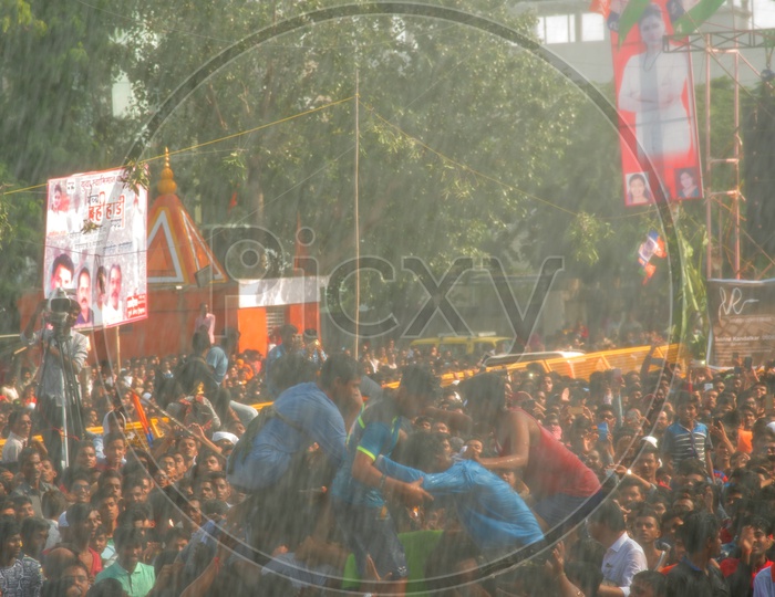 Image of Crowd Of Young Indian People Enjoying Making Human Pyramid At ...