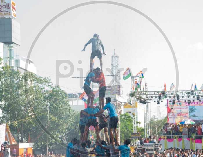 Image of Crowd Of Young Indian People Enjoying Making Human Pyramid At ...