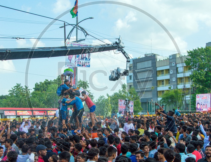 Image of Crowd Of Young Indian People Enjoying Making Human Pyramid At ...