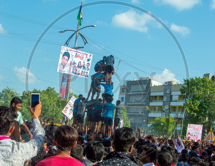 Image of Crowd Of Young Indian People Enjoying Making Human Pyramid At ...