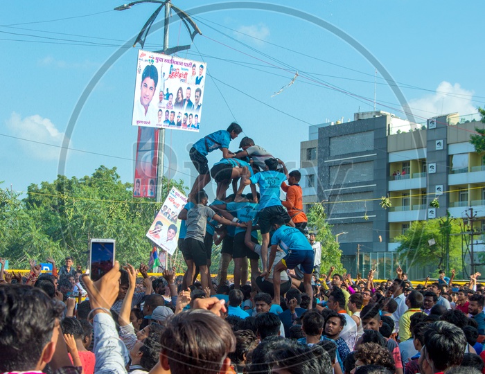 Image of Crowd Of Young Indian People Enjoying Making Human Pyramid At ...