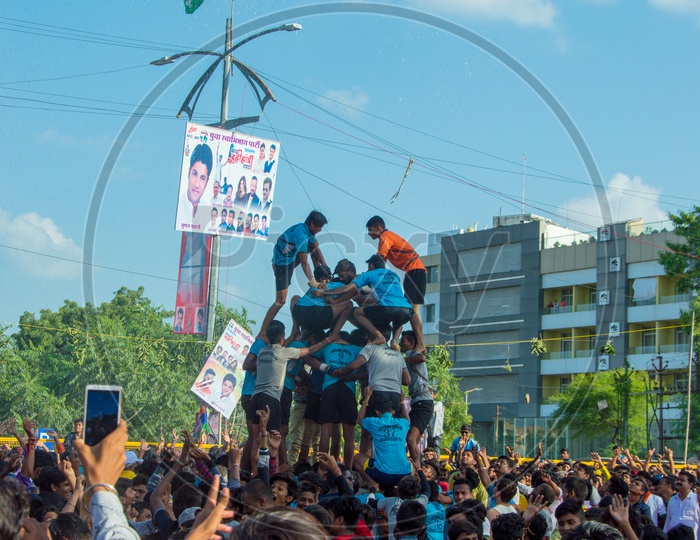 Image of Crowd Of Young Indian People Enjoying Making Human Pyramid At ...