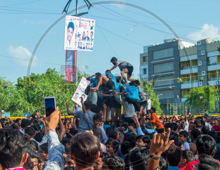 Image of Crowd Of Young Indian People Enjoying Making Human Pyramid At ...