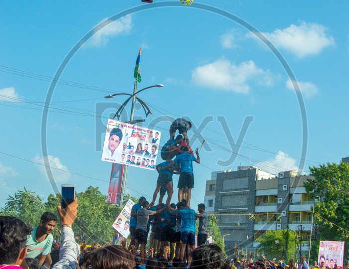 Image of Crowd Of Young Indian People Enjoying Making Human Pyramid At ...