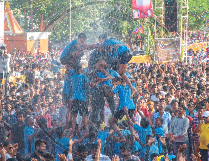 Image of Crowd Of Young Indian People Enjoying Making Human Pyramid At ...