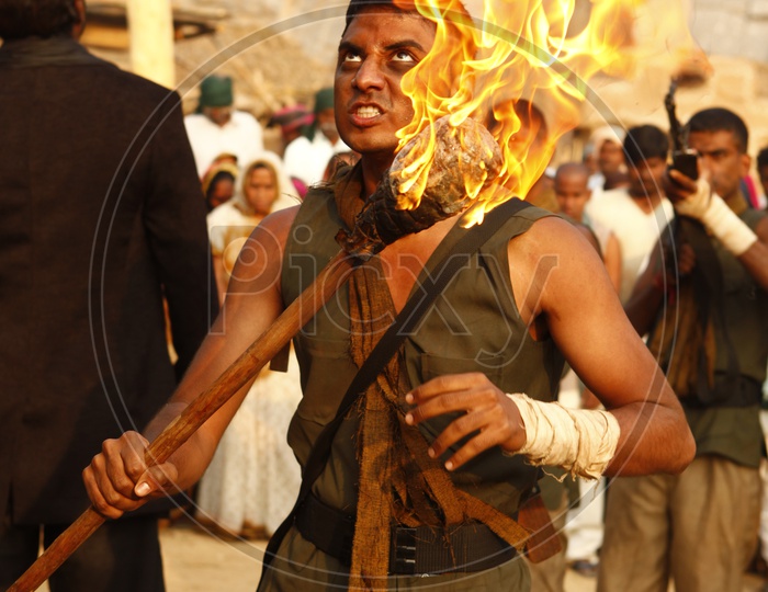 Image of An Aggressive Young Man With a Fire Stick in Hand-SB143552-Picxy