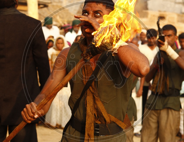 Image of An Aggressive Young Man With a Fire Stick in Hand-SN577791-Picxy