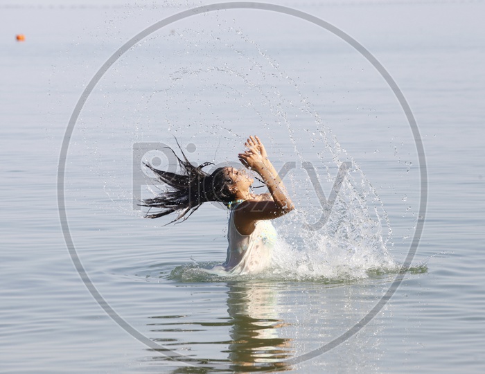 Image of Young Girl Making Water Splash With Hair-RR238272-Picxy