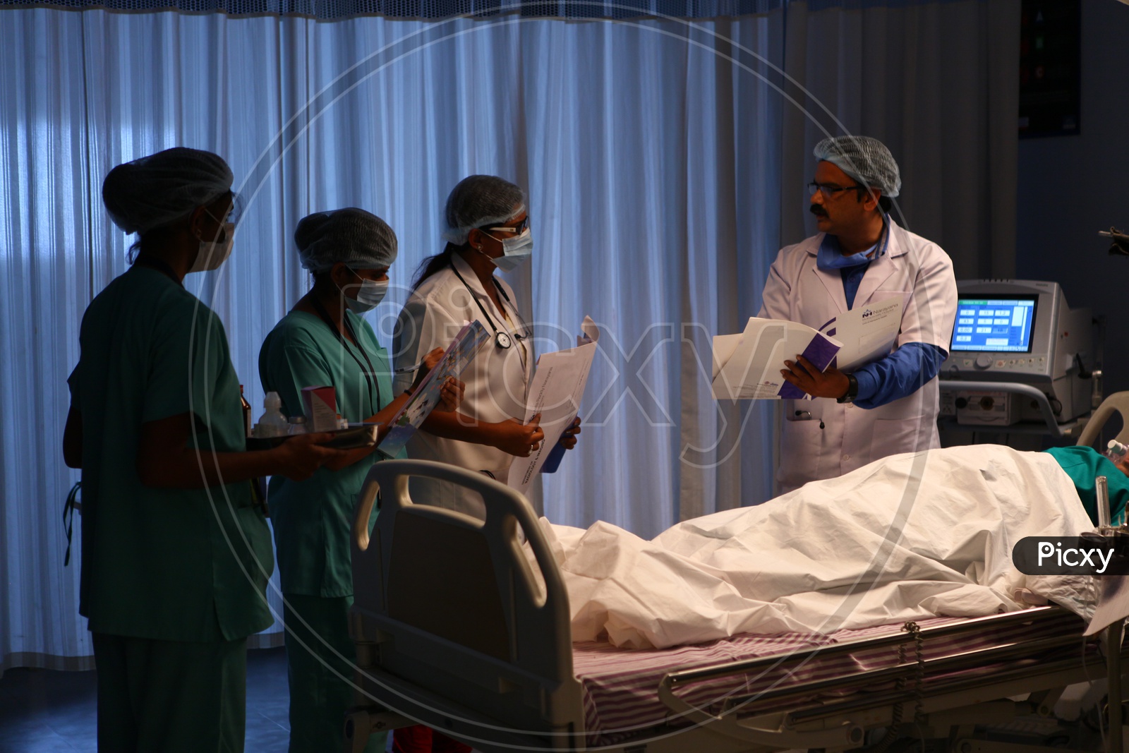 Image of Doctor Treating a Patient in a Hospital ICU operation Theater-QU098652-Picxy