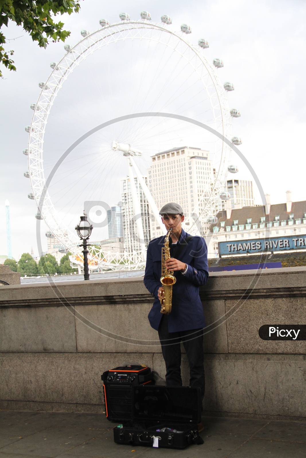 Image of Jazz musician playing a Saxophone with London Eye in ...