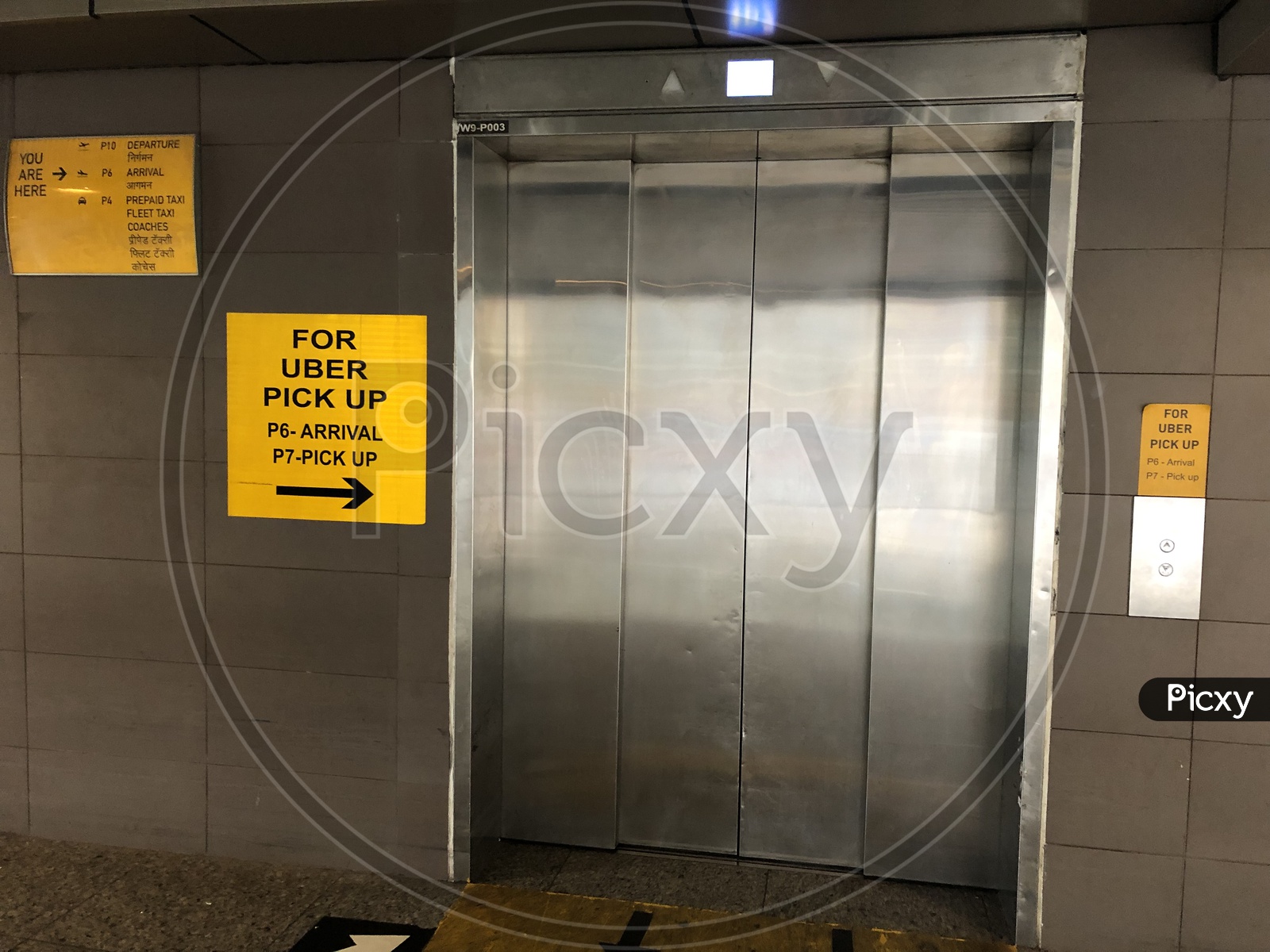 Image of Elevators at Terminal 2 with Uber Pick up Point sign board at ...