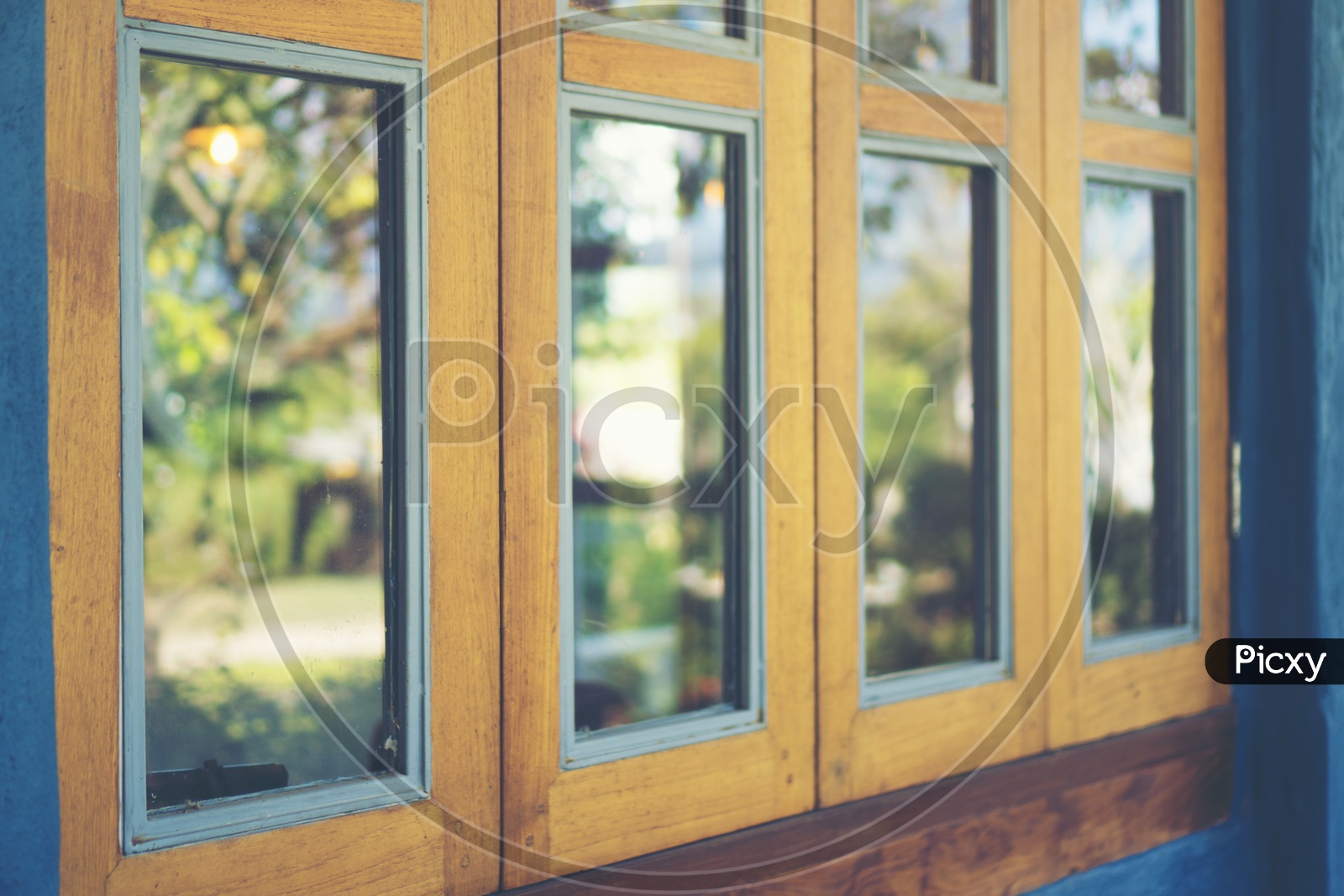 Image of Glass window with yellow and blue wooden frame-NM600284-Picxy