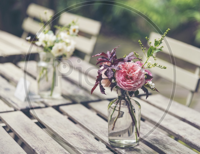 Image of Flower Vase With Beautiful Flowers on a Cafe Table-ZF044024-Picxy