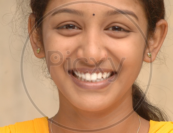 Image of Indian girl smiling with teeth-UT963186-Picxy