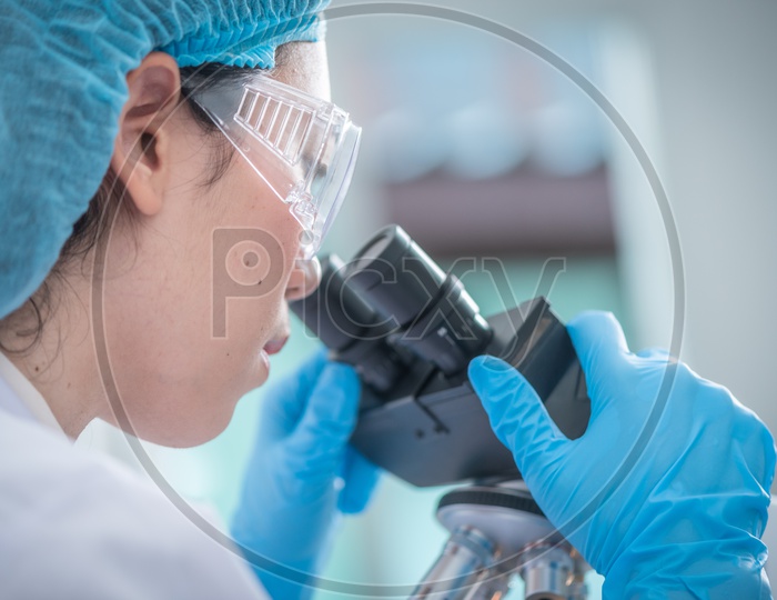 Image of Young Asian Researcher Using Microscope In a R&D Lab-AW694774 ...