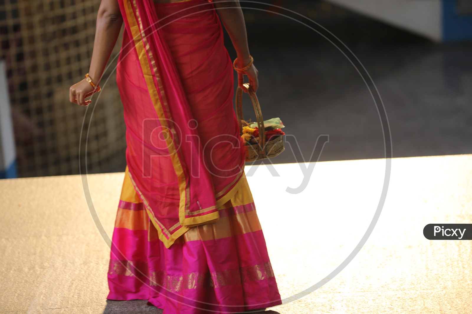 Image of Rear view of Traditional Indian girl with Puja accessories ...