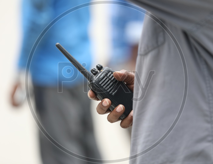 Image of Indian man with Walkie Talkie-JM527230-Picxy