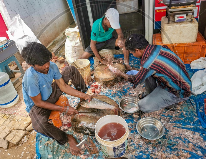 Image of Butcher Cleaning and Chopping Fish At a Market-OG797361-Picxy