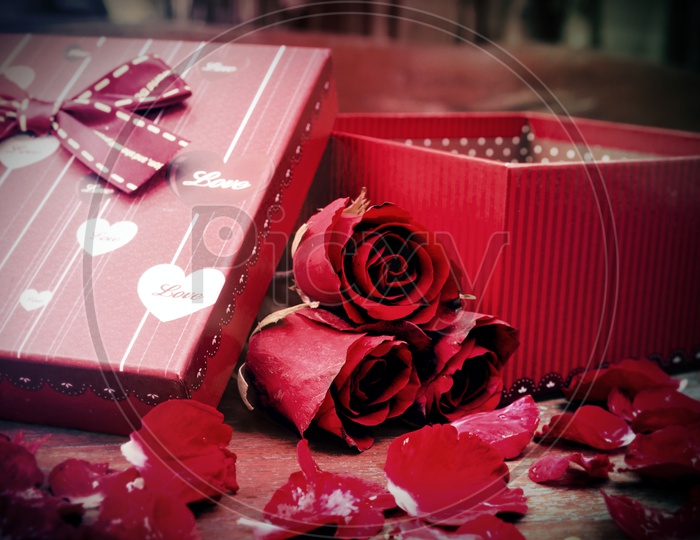 Image Of Red Roses And Gift Box Over A Wooden Background Forming Image Of Red Roses And Gift Box Over A Wooden Background Forming
