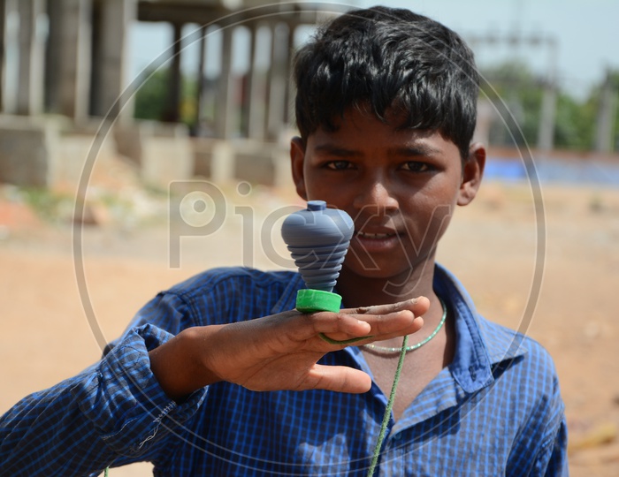 Image of Indian Children Playing with Spinning Top Or Bongaram-UM943794 ...