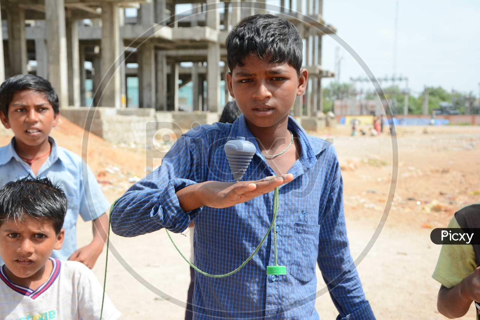 Image of Children Playing with Spinning Top Or Bongaram-VM503040-Picxy