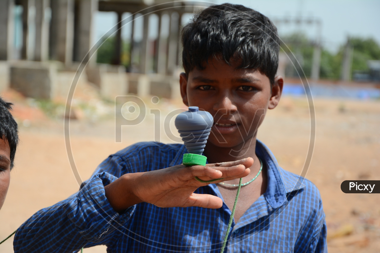 Image of Indian Children Playing with Spinning Top Or Bongaram-UM943794 ...