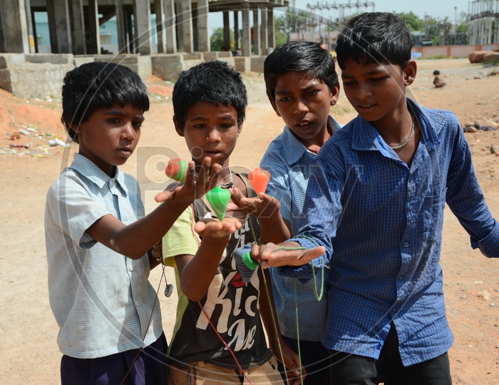 Image of Children Playing with Spinning Top Or Bongaram-VM503040-Picxy