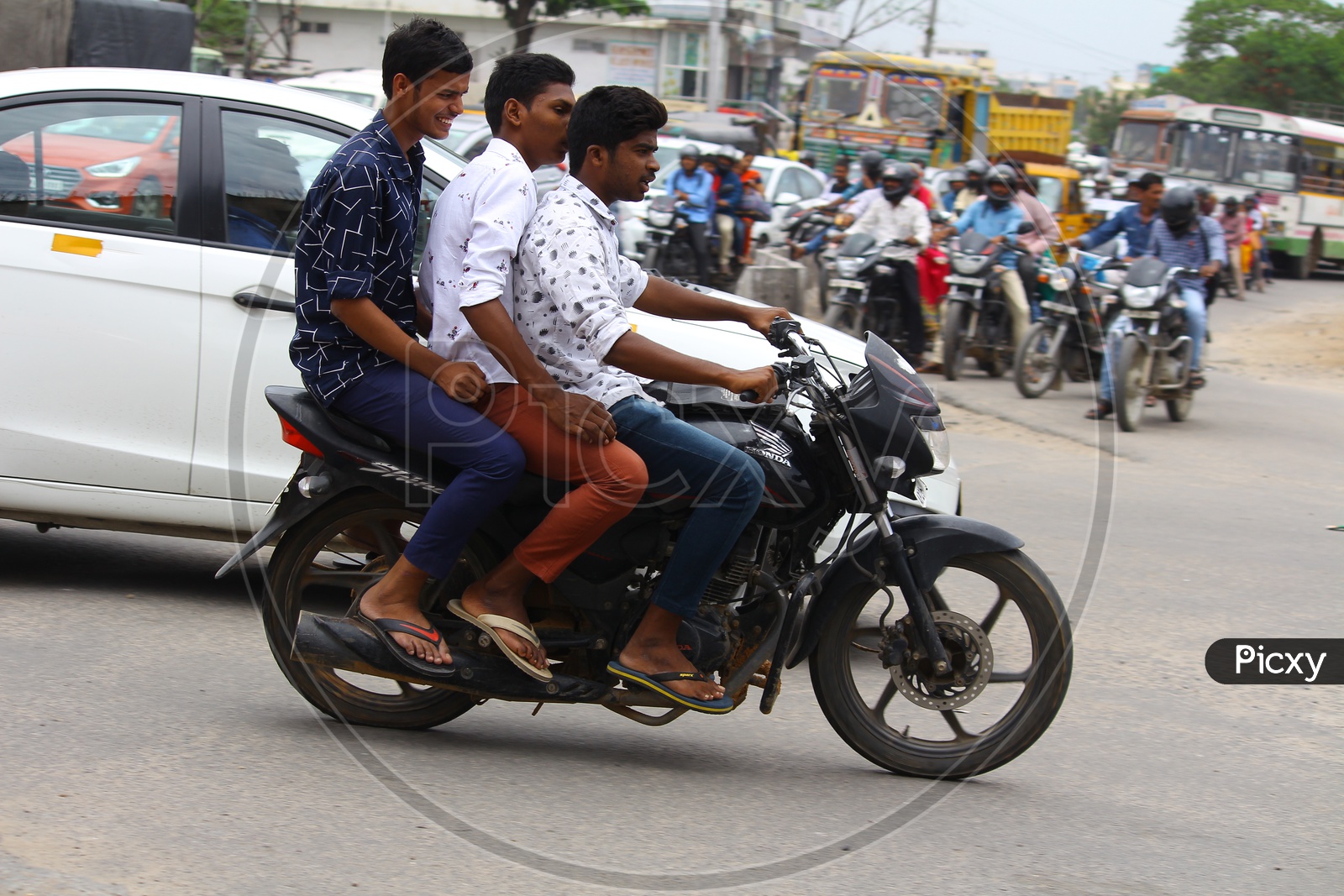 Image of City Commuters Traffic Rules Violation With Triple riding On ...