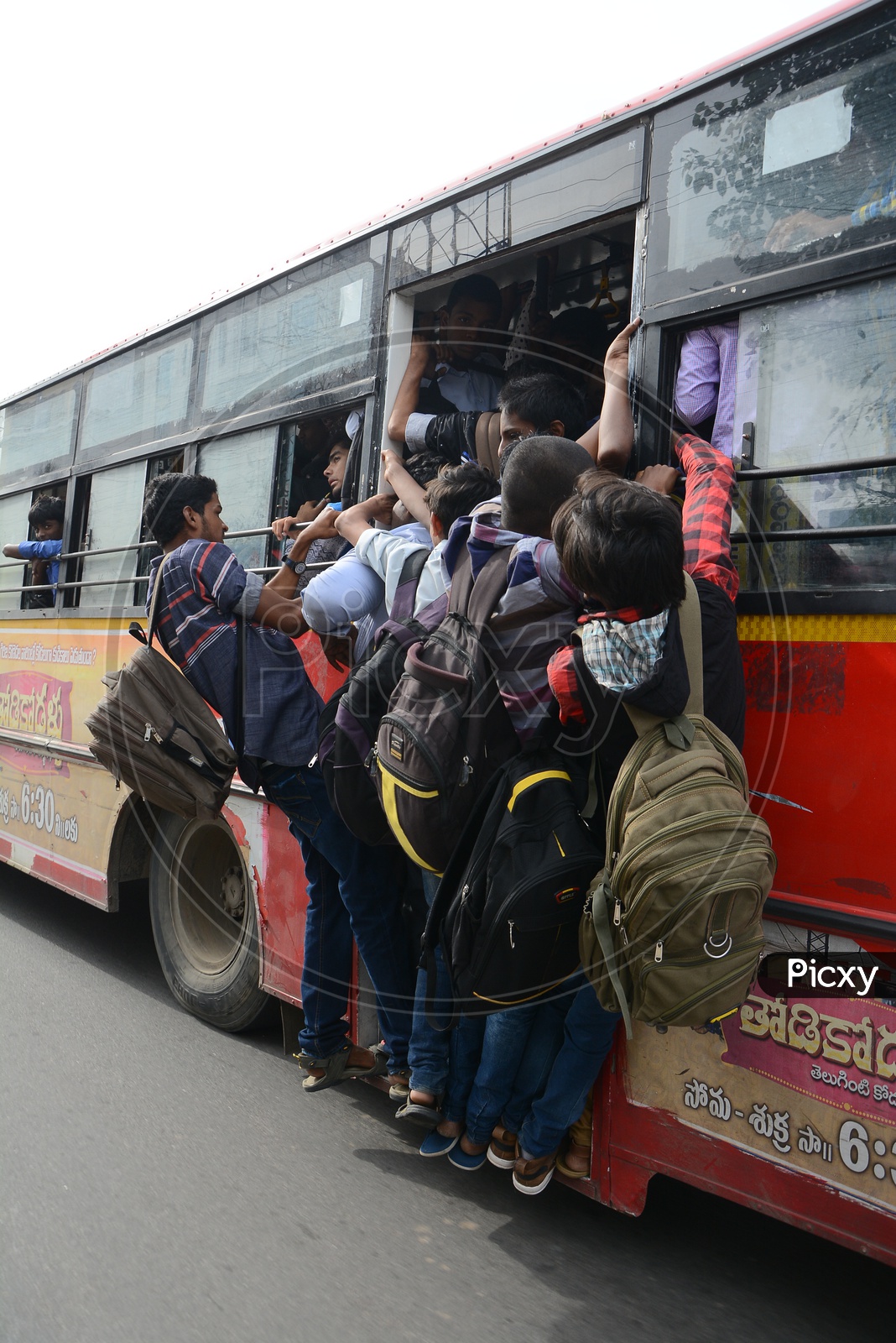 Image Of Foot Board Travelling In A City Bus By College Students Image Of Foot Board Travelling In A City Bus By College Students