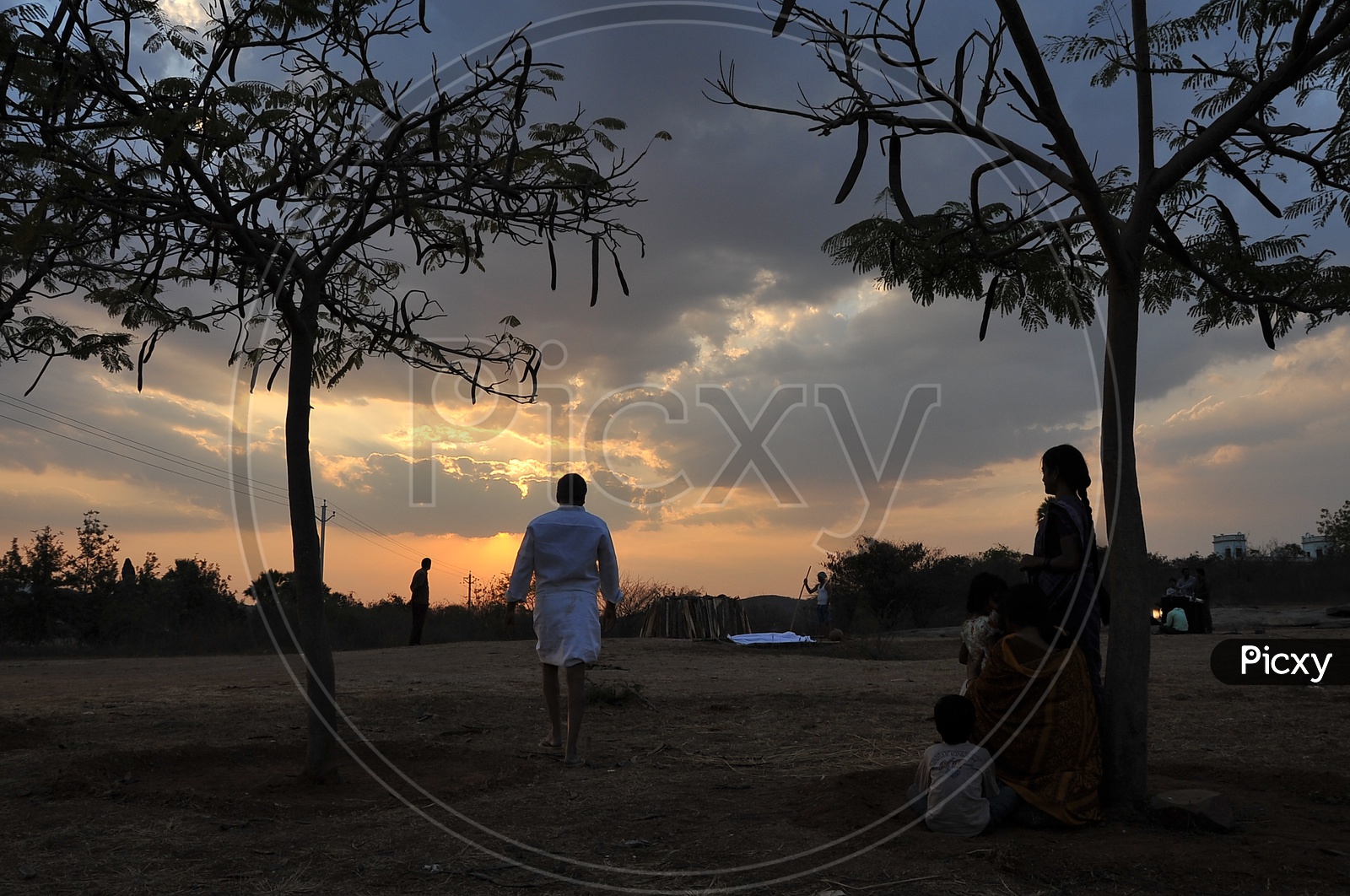 Image of Silhouette Indian Man wearing Dhoti walking during a sunset to ...