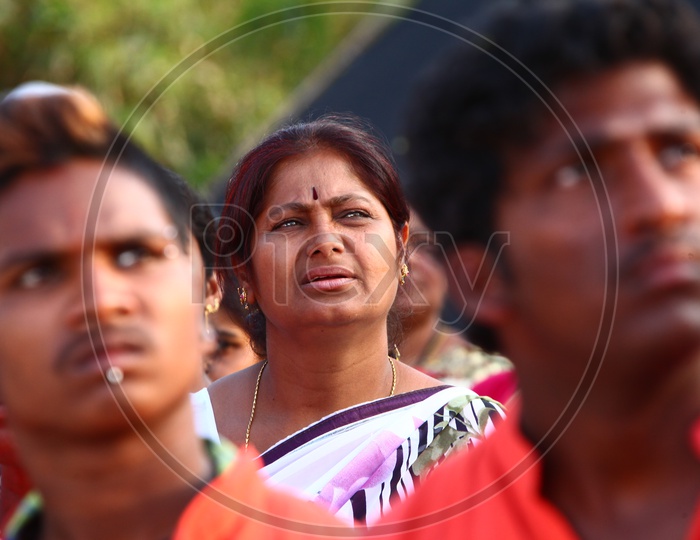 Image of Indian Women wearing a bindi amidst the costumed men-FF432062 ...