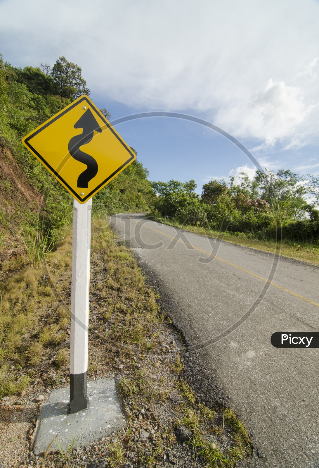 Image of S Curve Sign with Road and Sky in Background-TF505517-Picxy