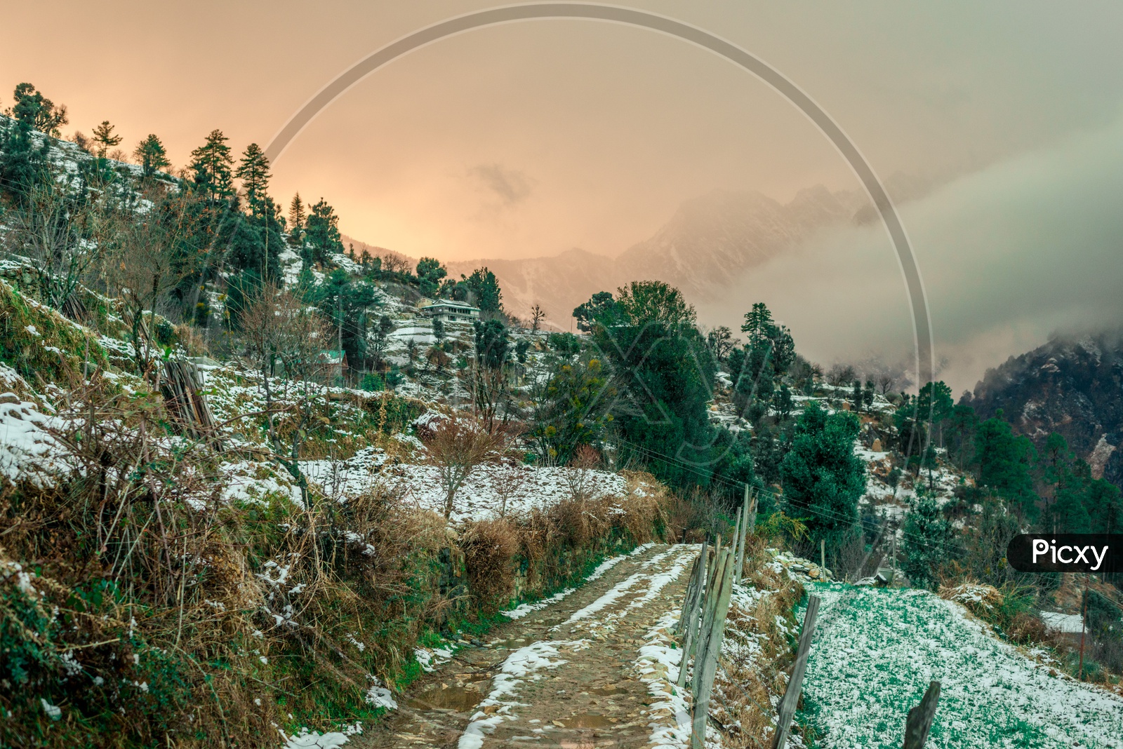 Image of A Mud Road Covered in Snow with Sunset in Sky Background ...