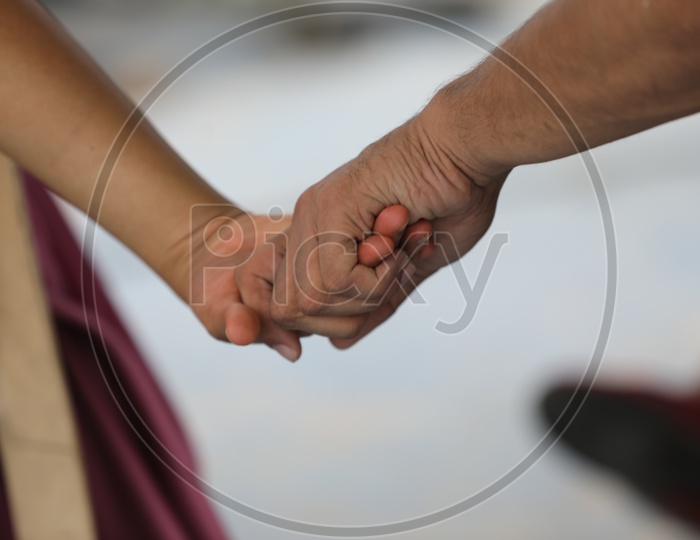 Image of A Man squeezing the palm of a girl-NC183630-Picxy