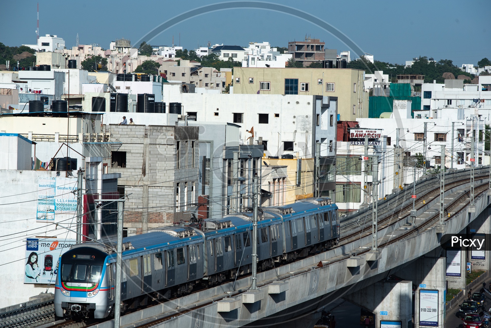Image of Hyderabad Metro Train running On Tracks With High rise ...