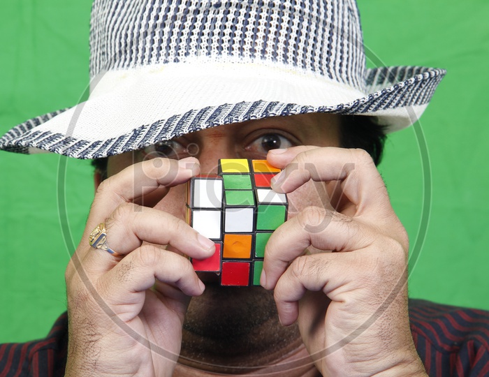 Image of An Indian Man with Rubik's Cube in hand-OO630969-Picxy