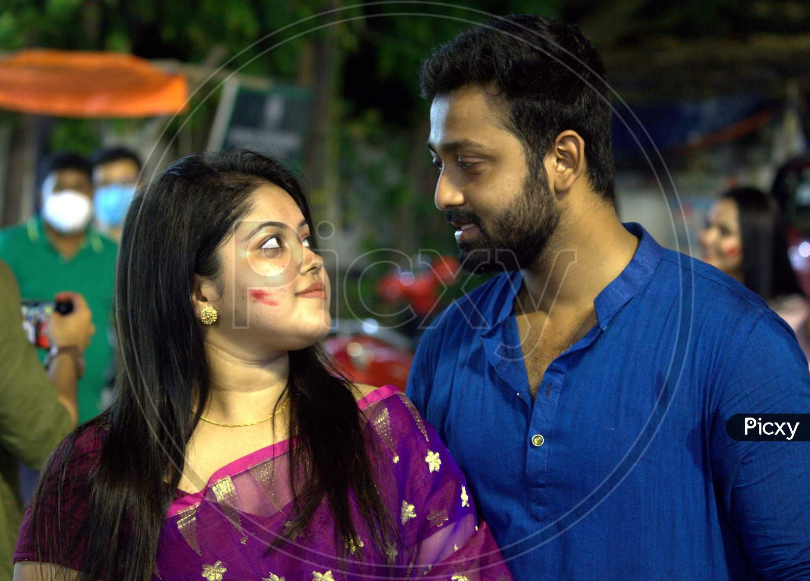 Image of A young indian bengali couple dressed in blue and purple ...