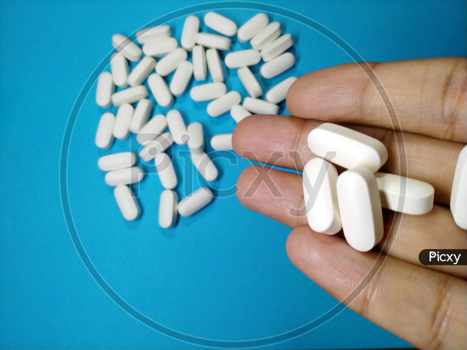 Image of White Drugs On Blue Blur Background,Blue and white capsules ...