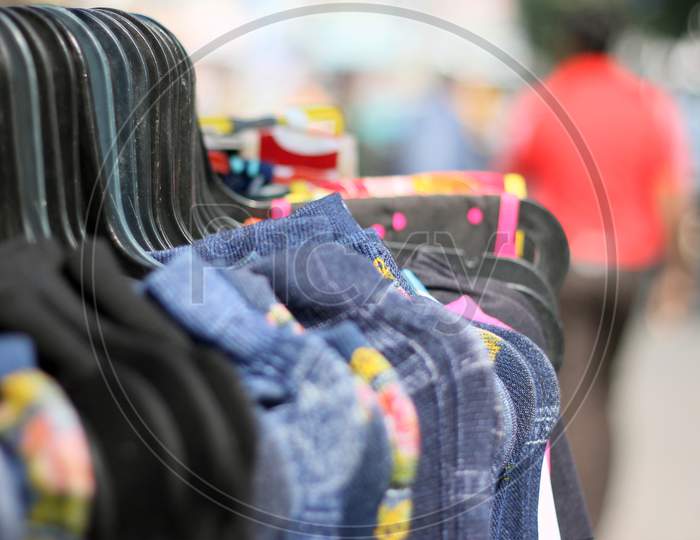 Image of Boys And Girls Ready-Made Clothing Store With Shopkeeper On ...