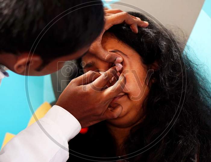 Image of Close-Up View Of Indian Male Doctor Checking Woman Patient Eye ...