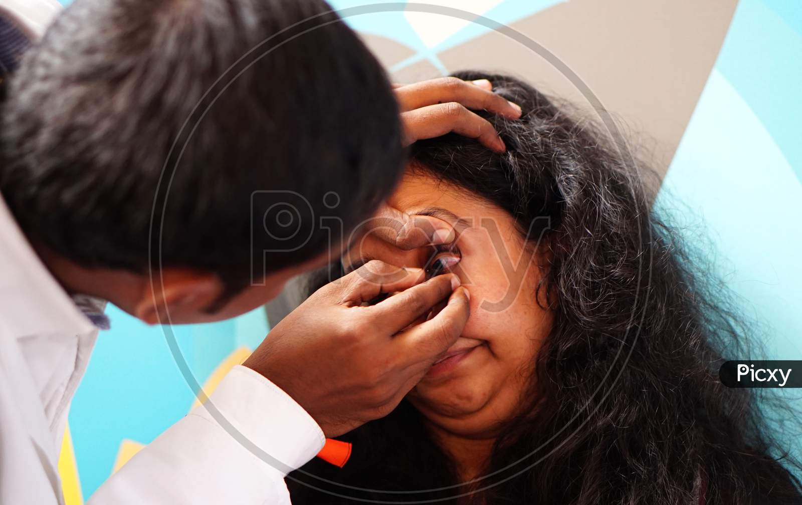 Image of Close-Up View Of Indian Male Doctor Checking Woman Patient Eye ...