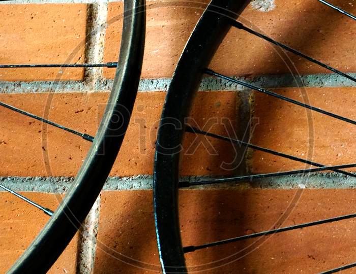Image of Rim Of Bicycle Wheel With Spokes As Background On Brick Wall ...