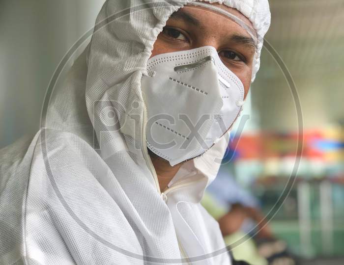 Image of A shopkeeper adjusts the cap of a PPE kit makeshift mannequin ...