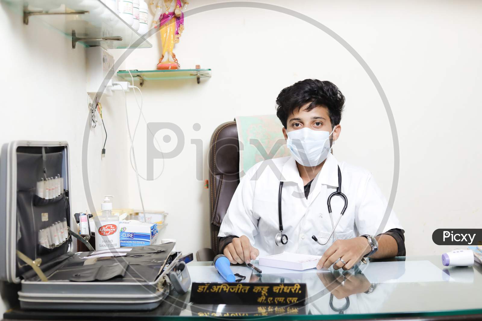 Image of Indian young doctor sitting on chair, doctor office, doctor in ...