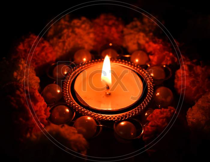 Image of Diya Or Lamp With Flame Of Fire Decorated With Marigold ...