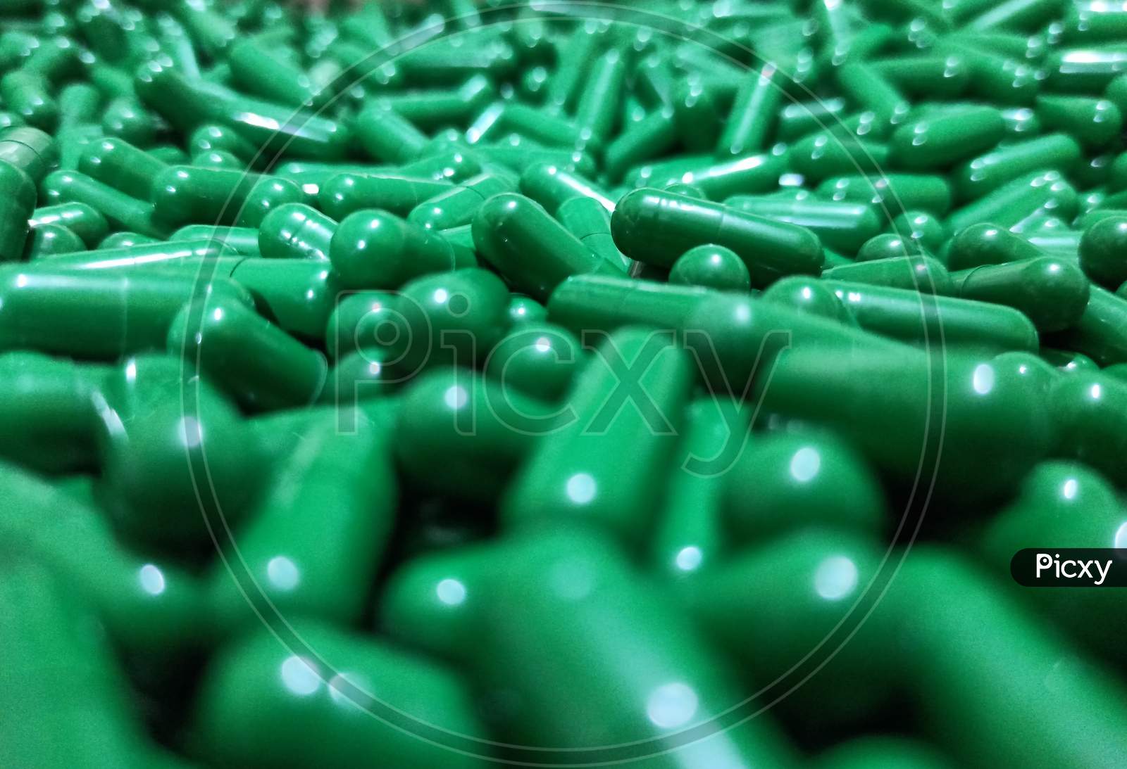 Image of Green medicine capsules in bulk. Selective focus and shallow ...