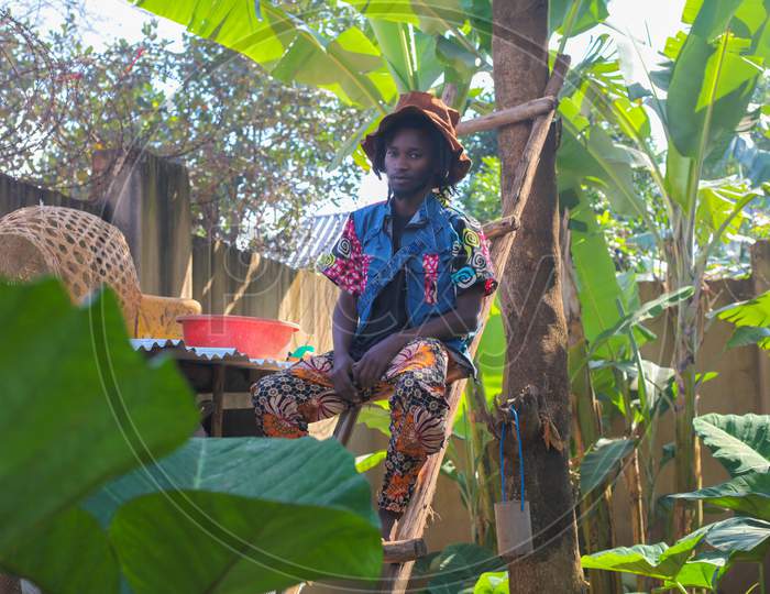 Image of Black African American man or youth high and climbs a tree in ...