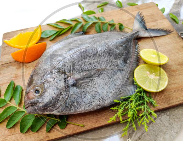Image of Closeup View Of Black Pomfret Fish Decorated With Fruits And ...