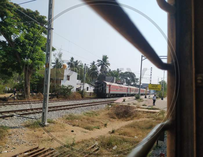 Image of Closeup Of Trains, Platform, People Walking And Name Board Of ...
