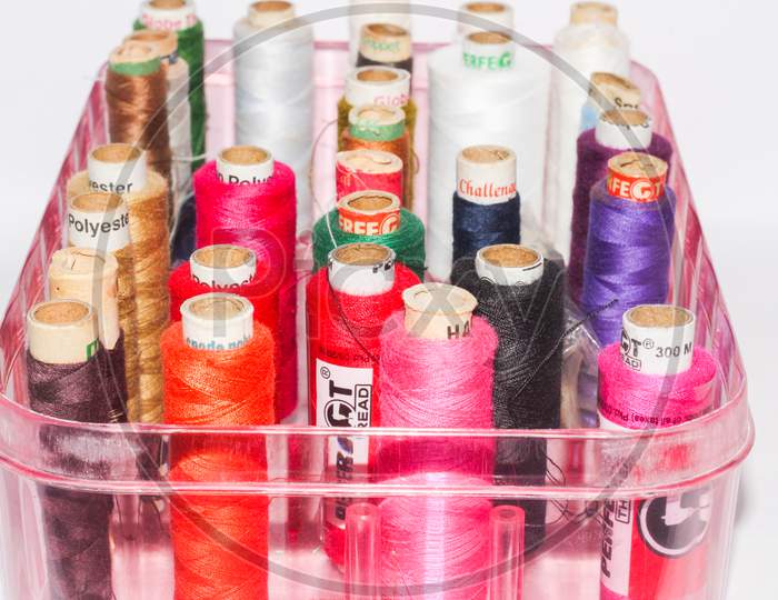 Image of semi transparent pink box with threads on white background ...